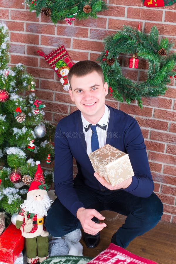 Young Guy Next To a Christmas Tree Stock Photo - Image of boxes, people ...