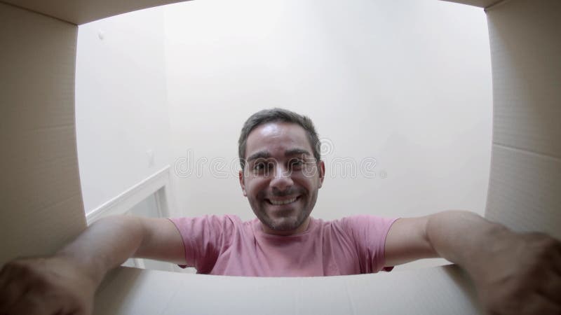 Young Guy Opening Carton Box, Looking Inside and Taking Things Stock ...