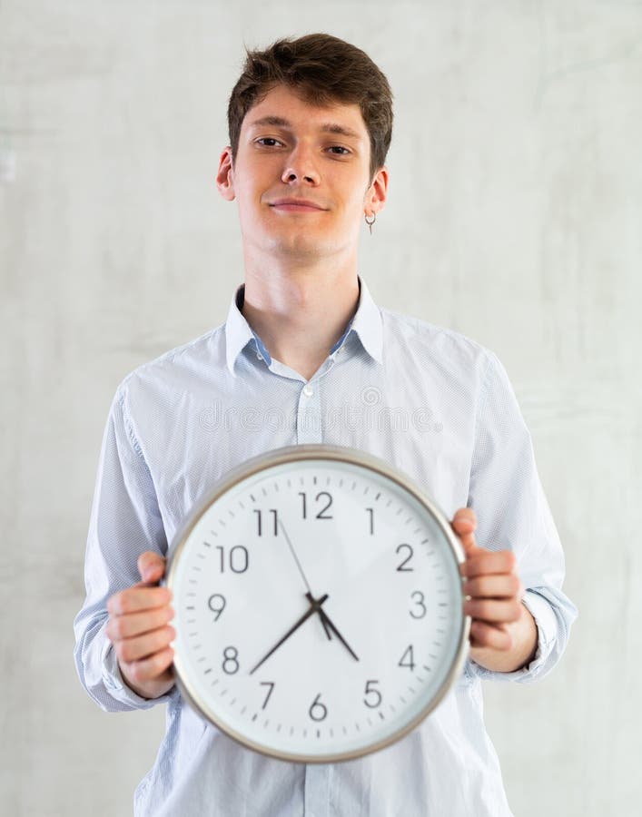 Young Guy Posing with Clock in Studio Stock Photo - Image of closeup ...