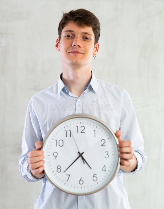 Young Guy Posing with Clock in Studio Stock Photo - Image of closeup ...