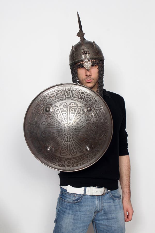 Young Guy is Posing in Studio with Helmet and Shield. Knight, Halloween ...
