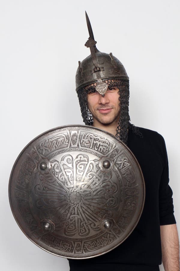 Young Guy is Posing in Studio with Helmet and Shield. Knight, Halloween ...