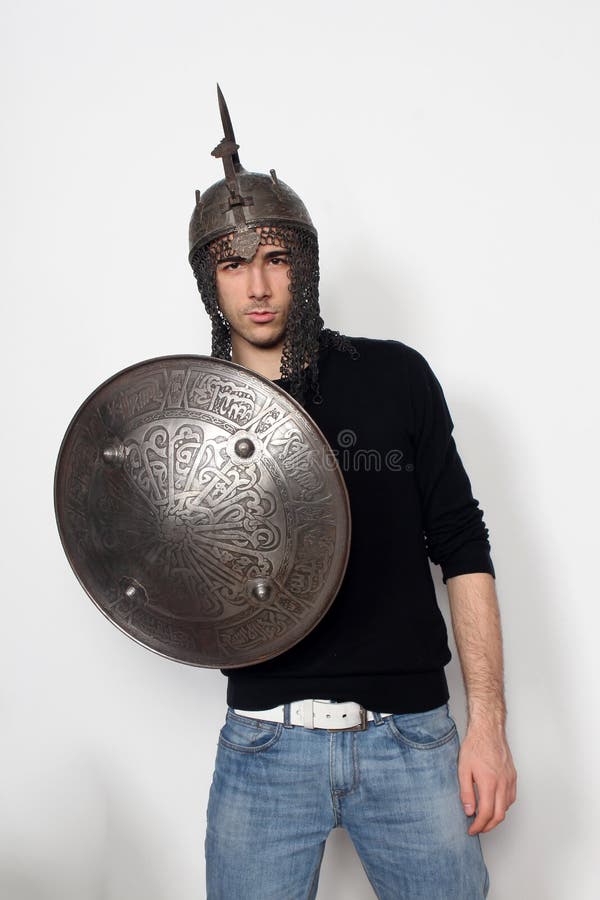 Young Guy is Posing in Studio with Helmet and Shield. Knight, Halloween ...