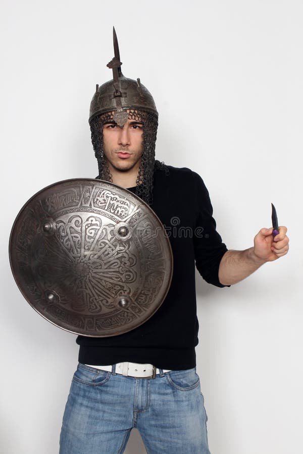 Young Guy is Posing in Studio with Helmet and Shield. Knight, Halloween ...