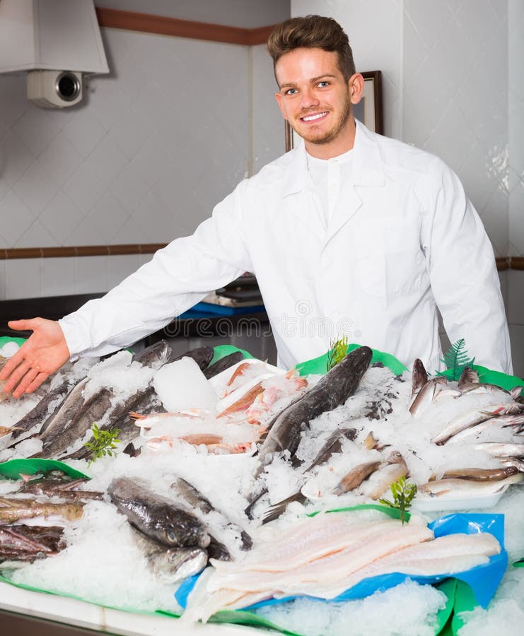 Young Guy Selling Chilled Fish and Seafood Stock Photo - Image of ...