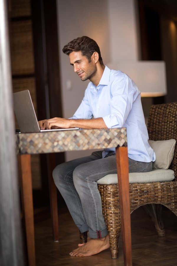 Young Guy Sitting at Home and Using Laptop Computer Stock Image - Image ...