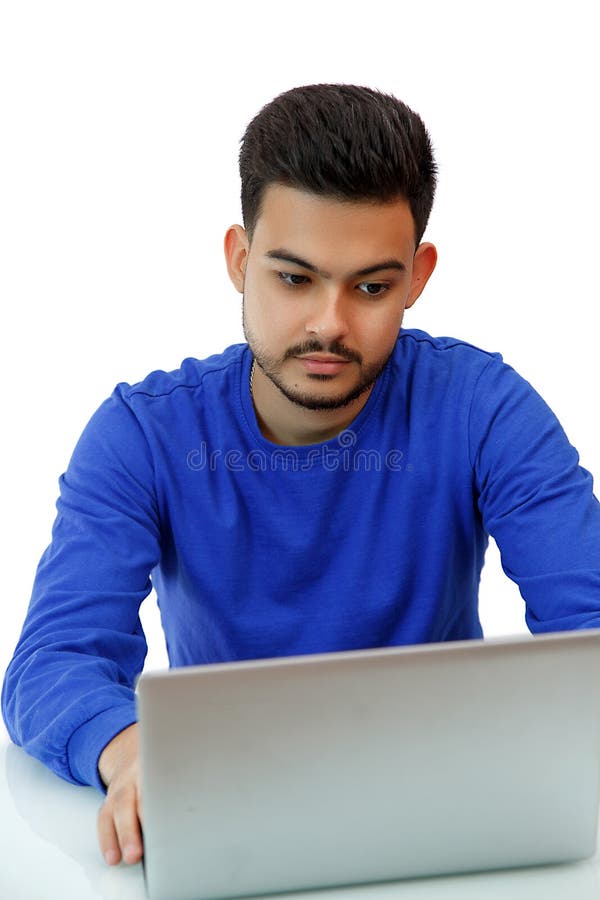 A Young Guy Sitting at a Laptop in Search of Work,doing Business on the ...