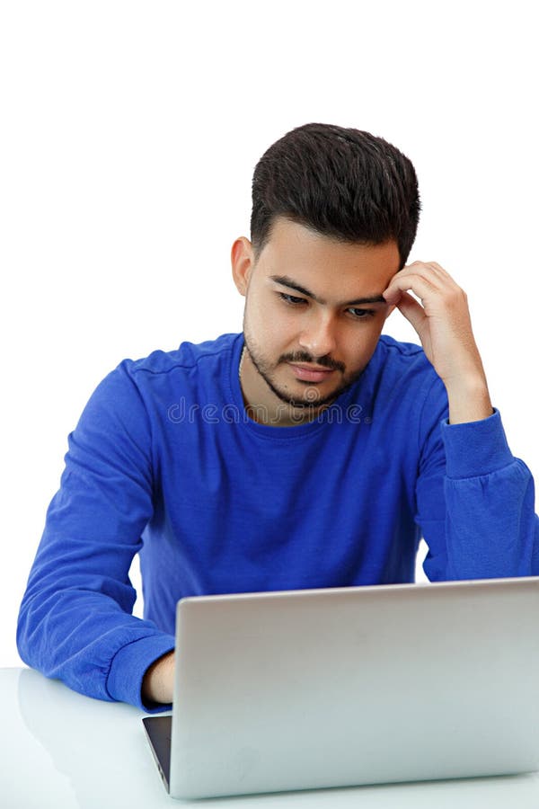 A Young Guy Sitting at a Laptop in Search of Work,doing Business on the ...