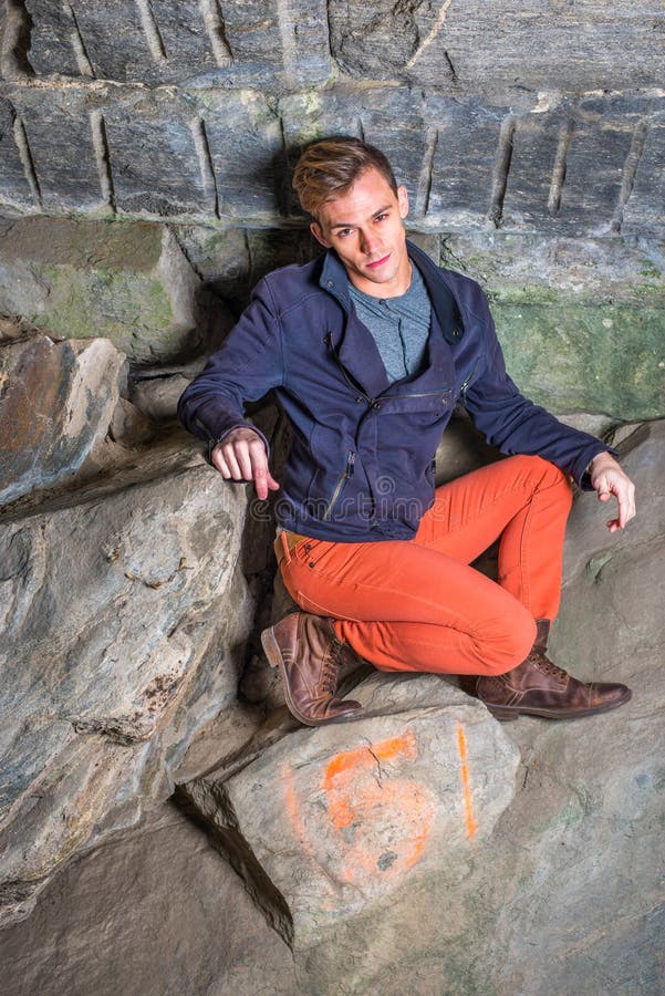 A Young Guy is Stressfully Fitting in a Corner of Rocks Stock Photo ...