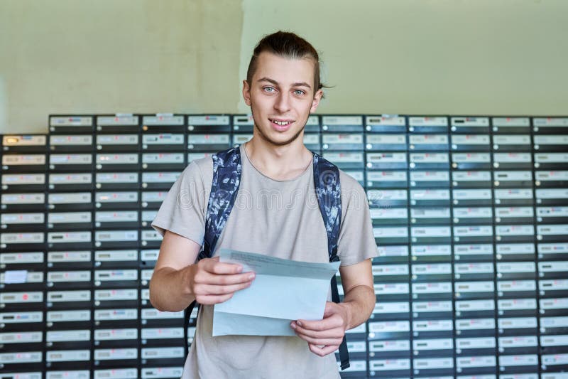 Young Guy Student Reading Important Mail Letter Near Mailboxes Stock ...
