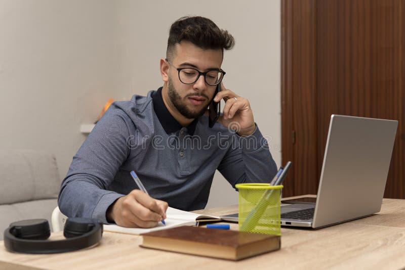 Young Guy Talking on the Phone Writing Notes Stock Photo - Image of ...