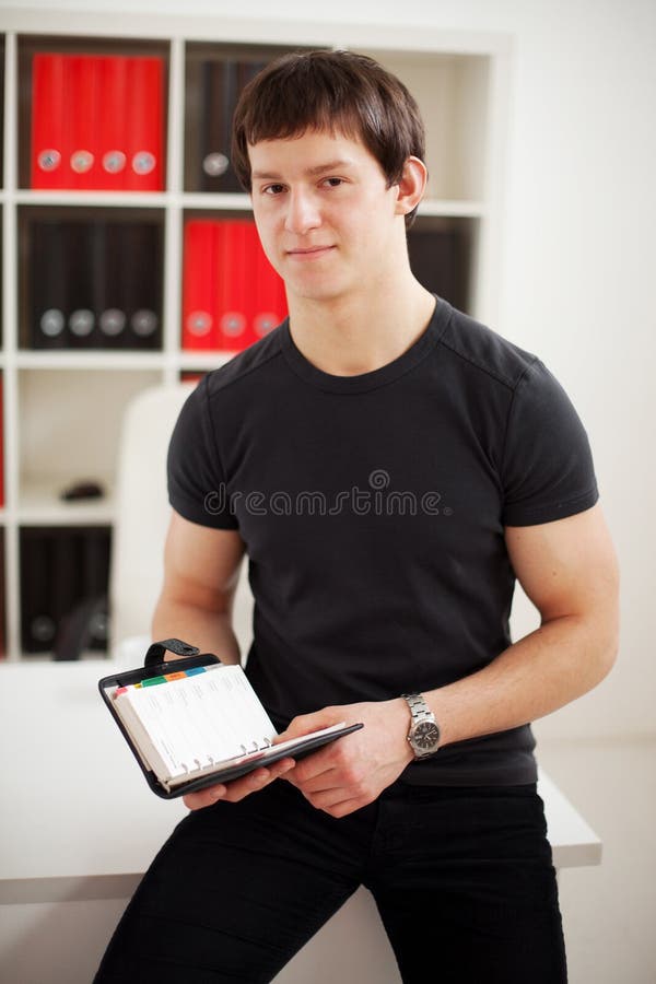 Young guy using diary stock photo. Image of confident - 29959008