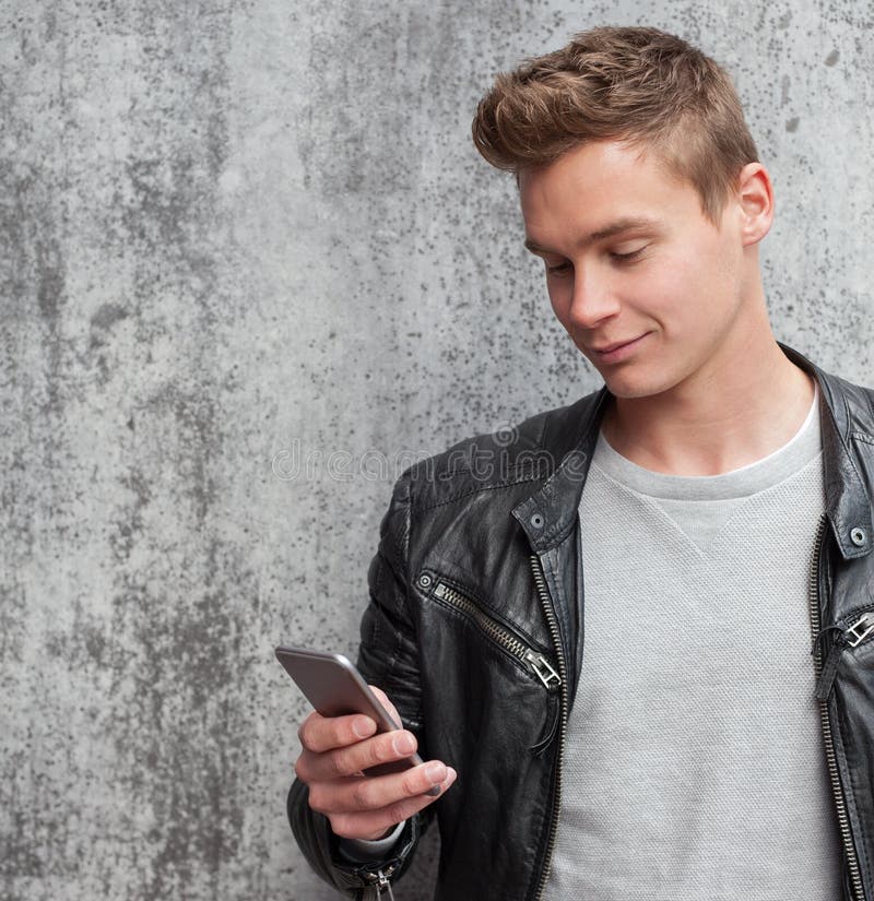 Young Guy Using Smart Phone Stock Photo - Image of concrete, teenager ...