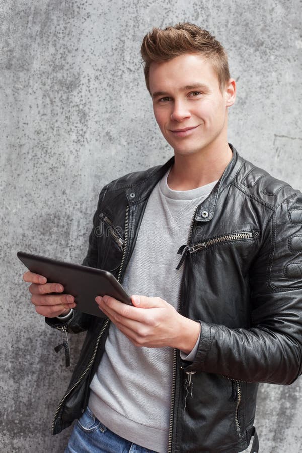 Young Guy Using Tablet Device Stock Photo - Image of pretty, jacket ...