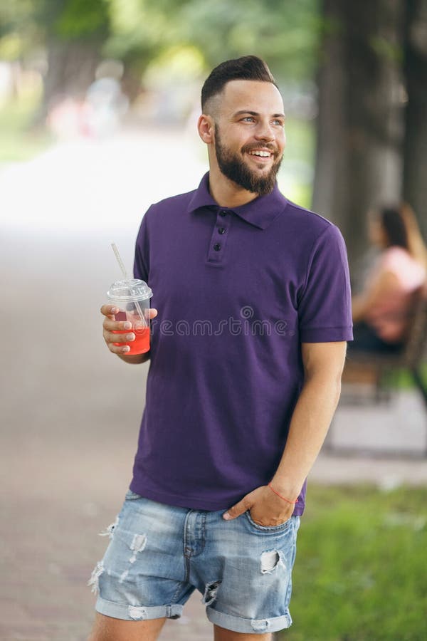A Young Guy Walking in the Park with Lemonade in the Spring. Spring Day ...
