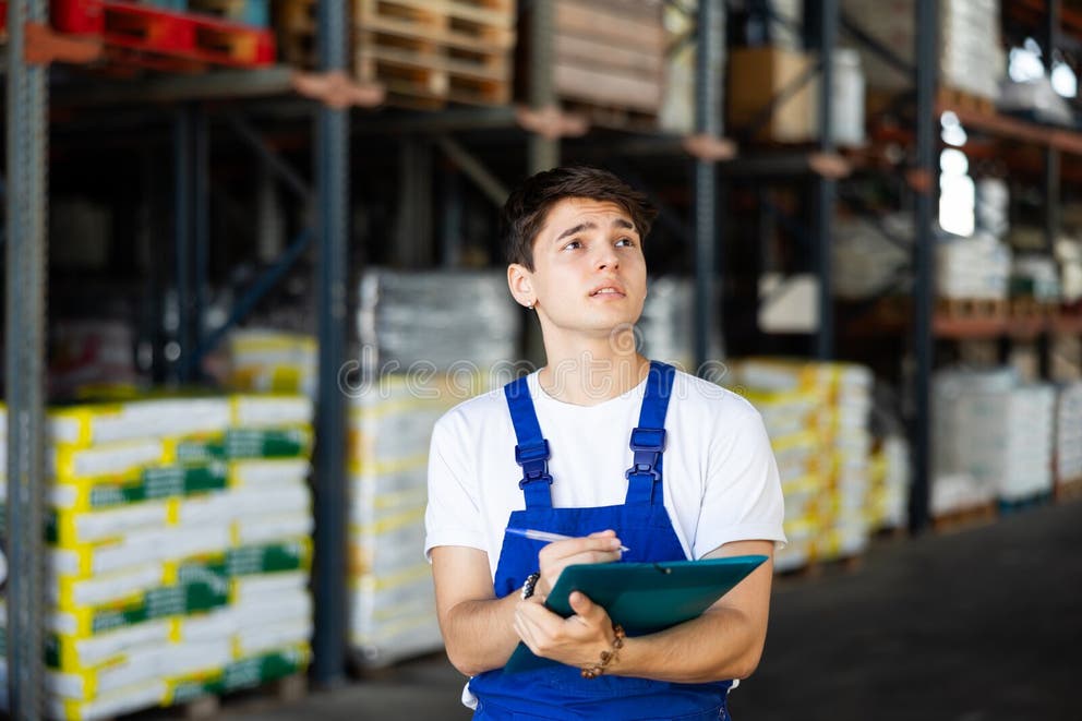 Young Guy Warehouse Worker Checking Documents Stock Photo - Image of ...