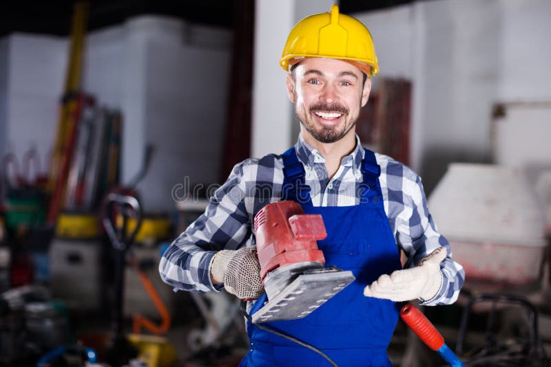 Young Guy Worker is Using Grinder for Construction Work Stock Image ...