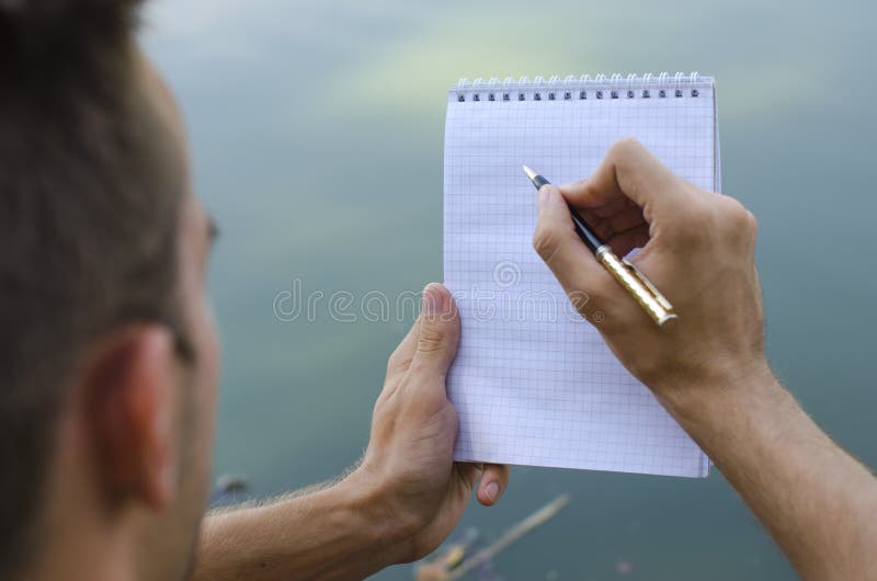 The Young Guy Writes in a Notebook Stock Image - Image of letter, looks ...