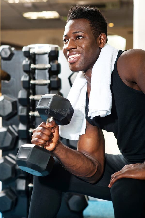 Young Gym Instructor Toning His Biceps Stock Image - Image of dumbbell ...