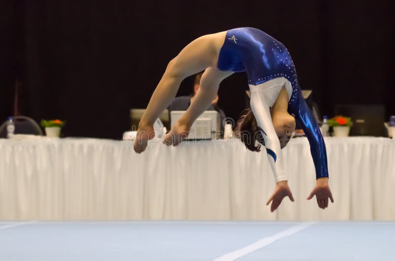 Young Gymnast Girl Performing Jump Back Handspring Stock Image - Image ...