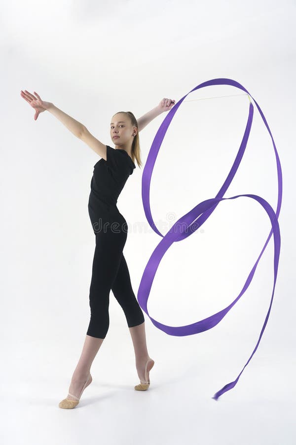 Young Gymnast in a Photo Studio Shows the Elements of Exercises with a ...
