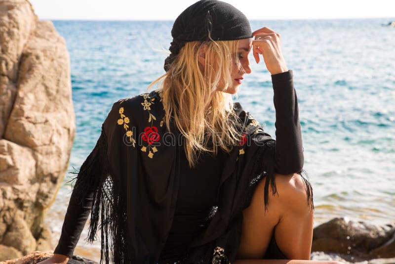 Young Gypsy Meditating on the Rocky Beach Stock Photo - Image of ...