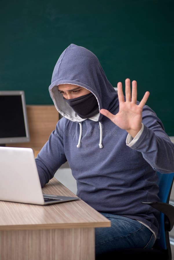 Young Male Hacker Sitting in the Classroom Stock Photo - Image of ...