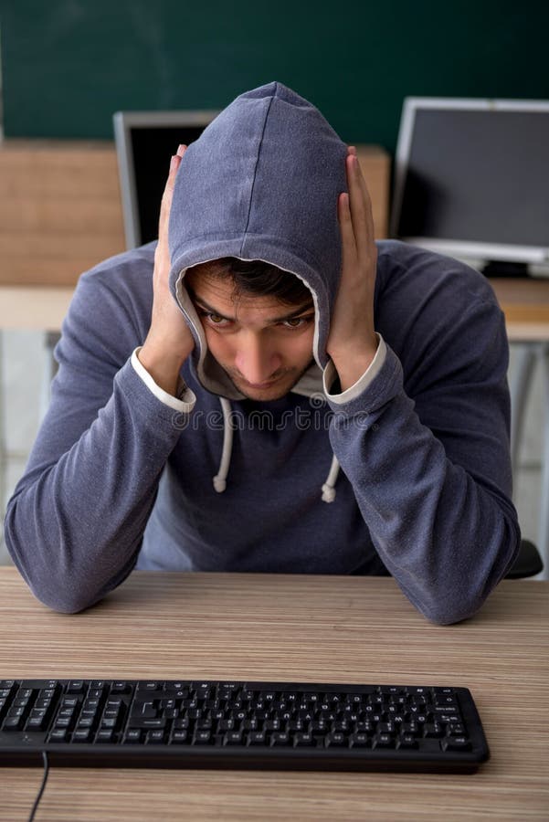 Young Male Hacker Sitting in the Classroom Stock Photo - Image of ...