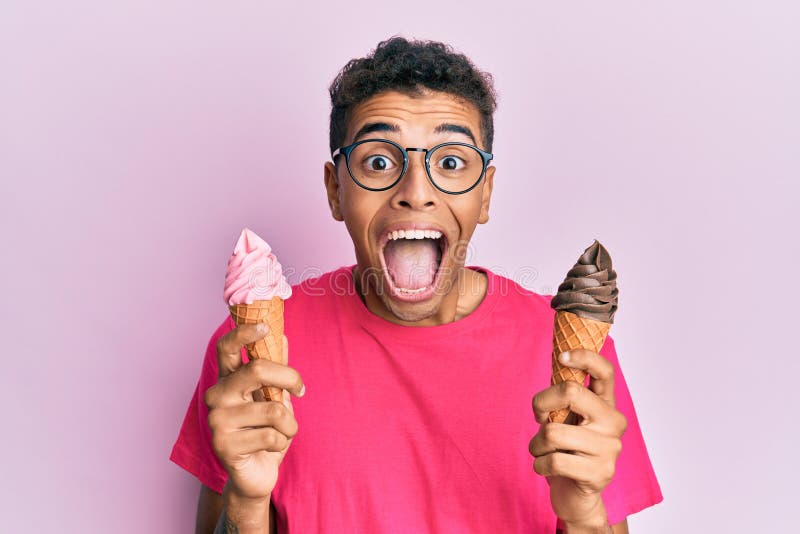 Young Handsome African American Man Holding Ice Cream Cones Celebrating