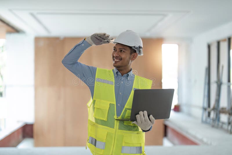 Young Handsome Asian Engineer Holding Laptop Looking Forward and ...