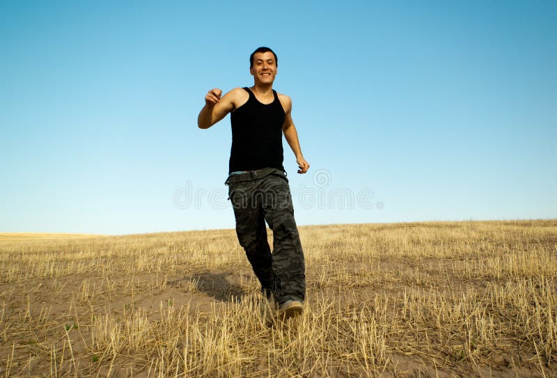 Young Handsome Asian Man Running Stock Photo - Image of running, yellow ...