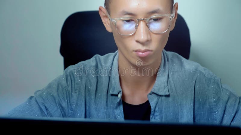 Young Handsome Asian Man Using His Laptop, Sitting at Desk in Office ...