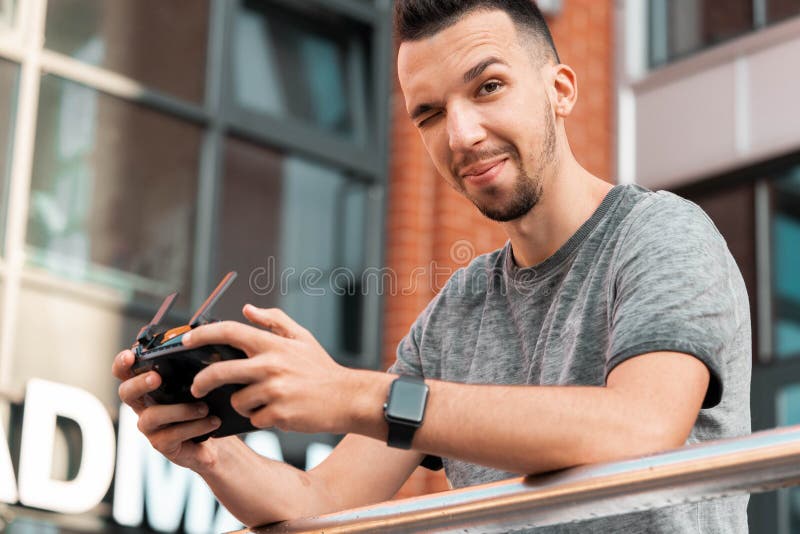Young Handsome Brunette Man Launching Drone Quadcopter and Holding ...