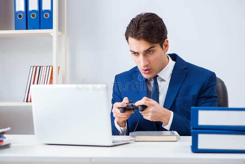 The Young Handsome Businessman Playing Computer Games at Work Office ...