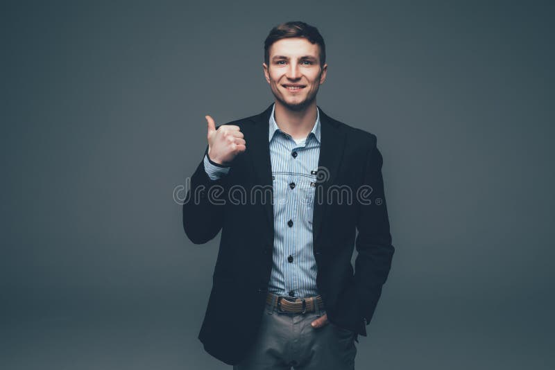 Young Handsome Businessman Pointing with Finger on Back on Grey Stock ...