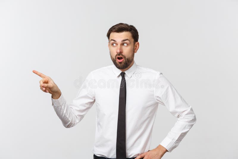 Young Handsome Businessman Pointing To Something Using a Finger ... Young Handsome Businessman Pointing To Something Using a Finger ...
