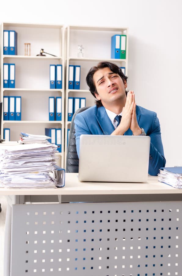 The Young Handsome Busy Employee Sitting in Office Stock Photo - Image ...