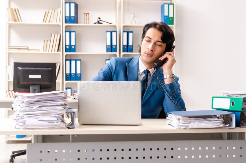 The Young Handsome Busy Employee Sitting in Office Stock Image - Image ...