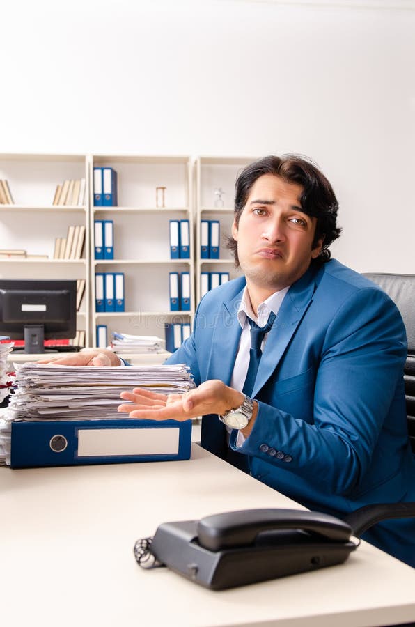 The Young Handsome Busy Employee Sitting in Office Stock Image - Image ...