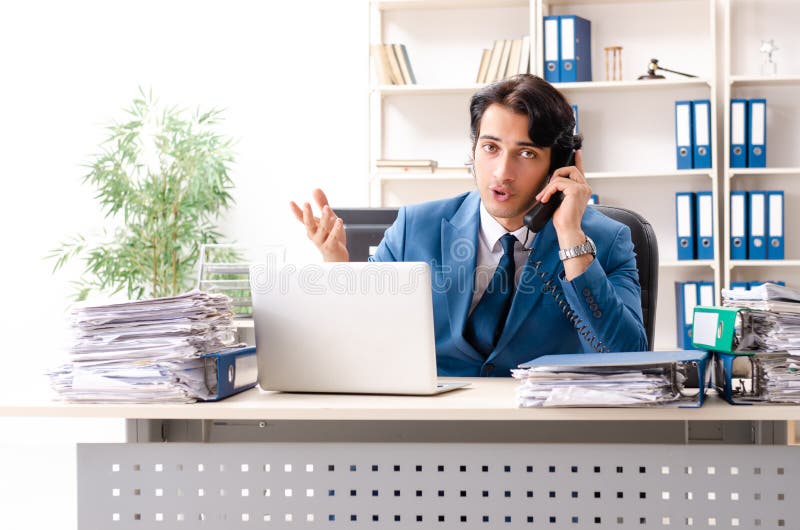 The Young Handsome Busy Employee Sitting in Office Stock Photo - Image ...