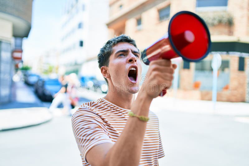 Young Handsome Caucasian Man Screaming Using Megaphone at City Stock ...