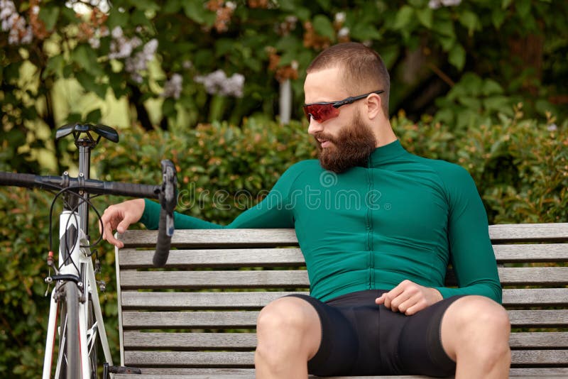 Young Handsome Cyclist is Resting after a Bike Ride in the Park Stock ...