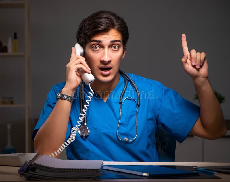 Young Handsome Doctor Working Night Shift in Hospital Stock Photo ...