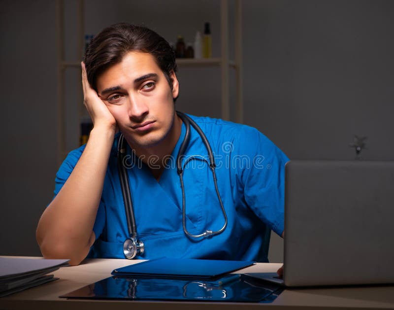 Young Handsome Doctor Working Night Shift in Hospital Stock Photo ...
