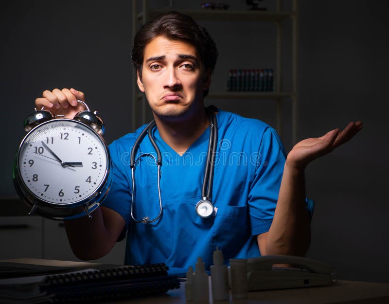 Young Handsome Doctor Working Night Shift in Hospital Stock Photo ...
