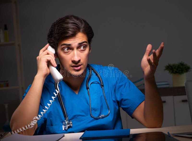 Young Handsome Doctor Working Night Shift in Hospital Stock Photo ...