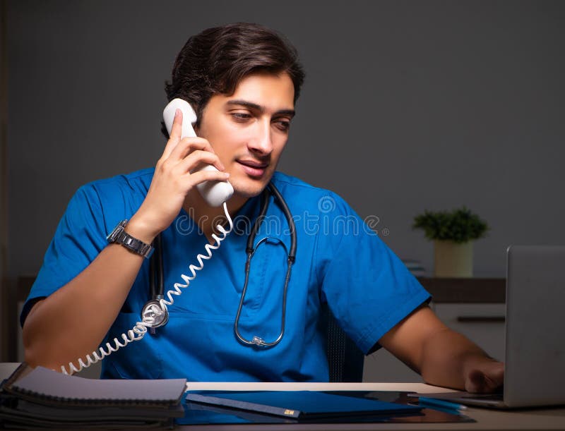 Young Handsome Doctor Working Night Shift in Hospital Stock Photo ...