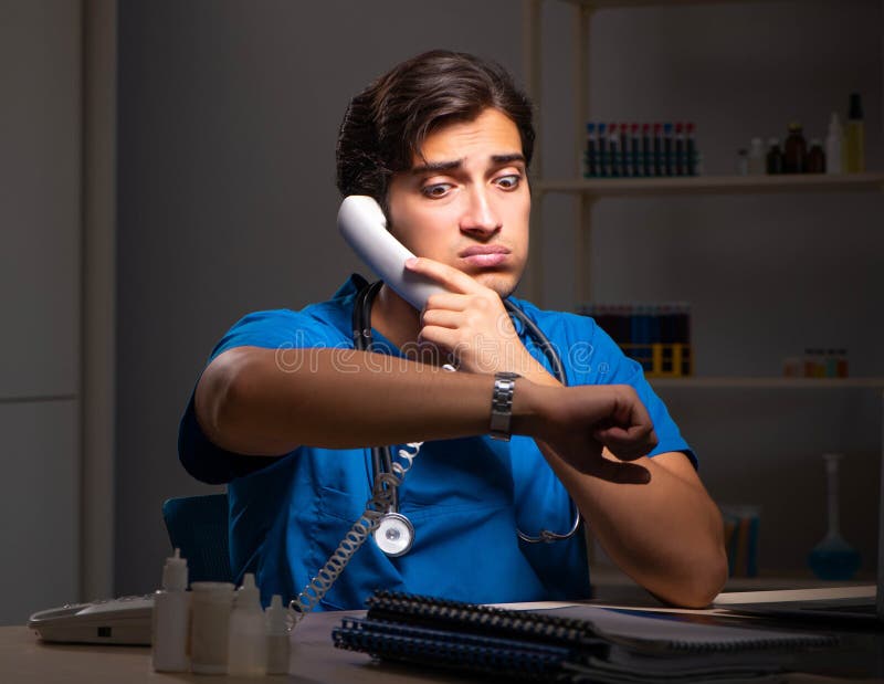 Young Handsome Doctor Working Night Shift in Hospital Stock Image ...