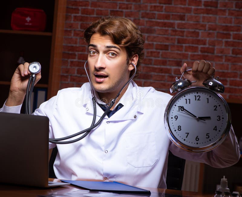 Young Handsome Doctor Working Night Time at the Hospital Stock Image ...