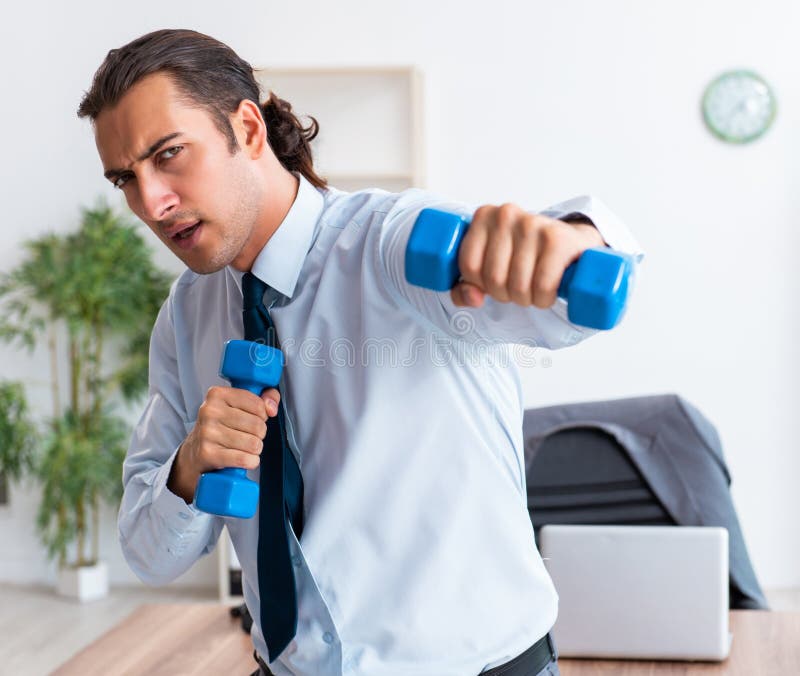 Young Handsome Employee Doing Sport Exercises at Workplace Stock Image ...